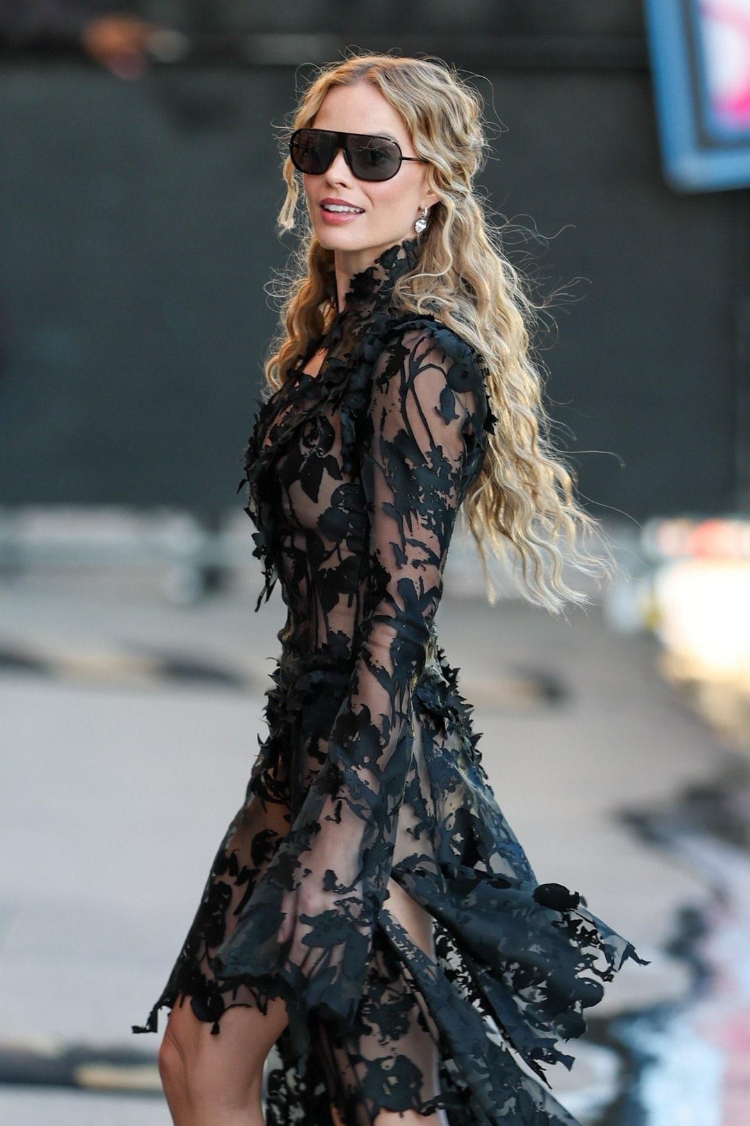 Margot Robbie wearing Alexander McQueen on Jimmy Kimmel Live to promote ...